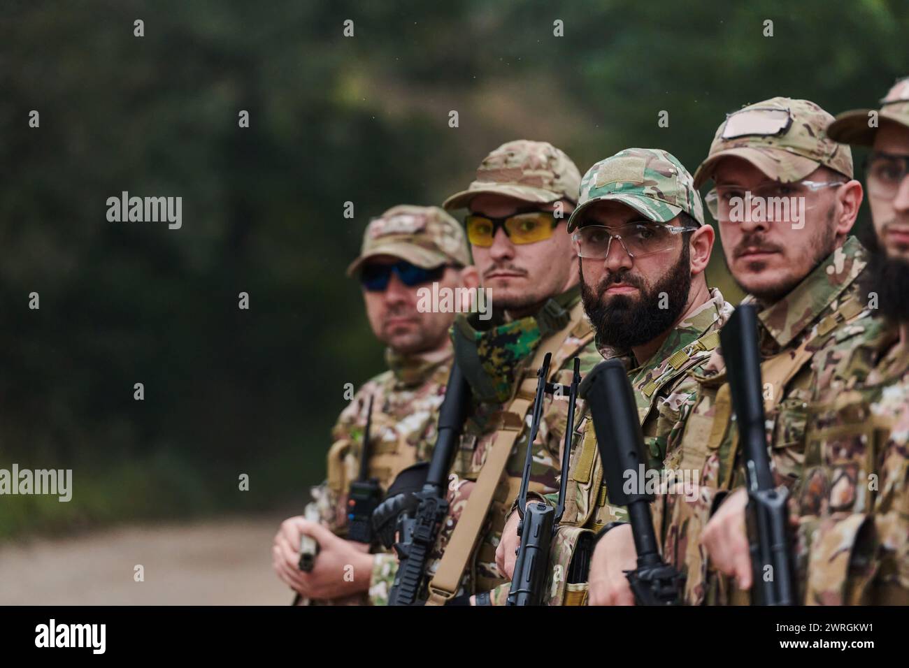 Soldier fighters standing together with guns. Group portrait of US army ...