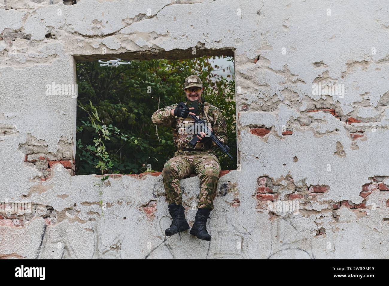 a soldier sits by the window of a recently conquered house, reflecting ...
