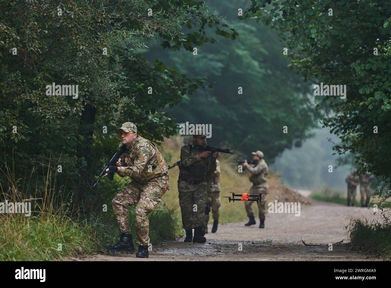 Elite military unit parading and securing the forest, utilizing drones ...