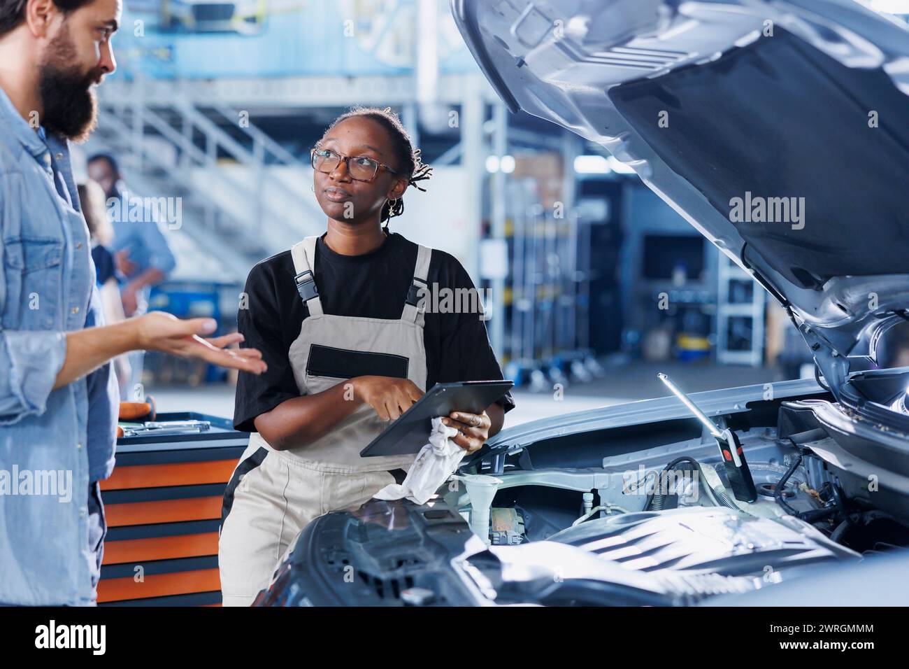 Mechanic at auto repair shop conducts annual vehicle checkup, informing ...
