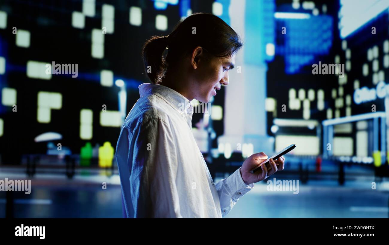 Man walking around city buildings at night, scrolling on ecommerce ...