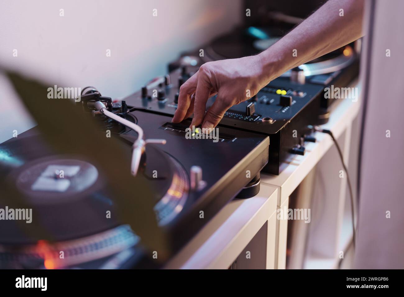 Dj mixing tracks on professional turntable at event Stock Photo - Alamy