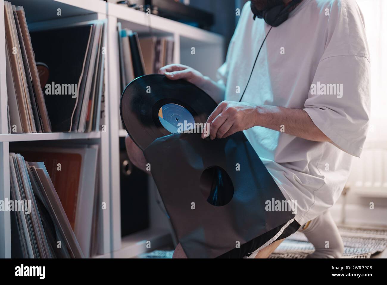 Music enthusiast browsing vinyl records at home Stock Photo - Alamy