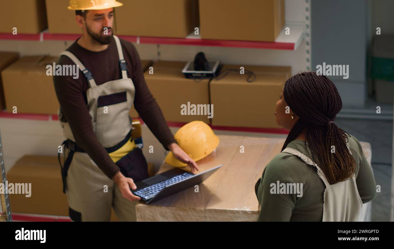 Chief supply chain officer and worker perform warehouse inventory ...