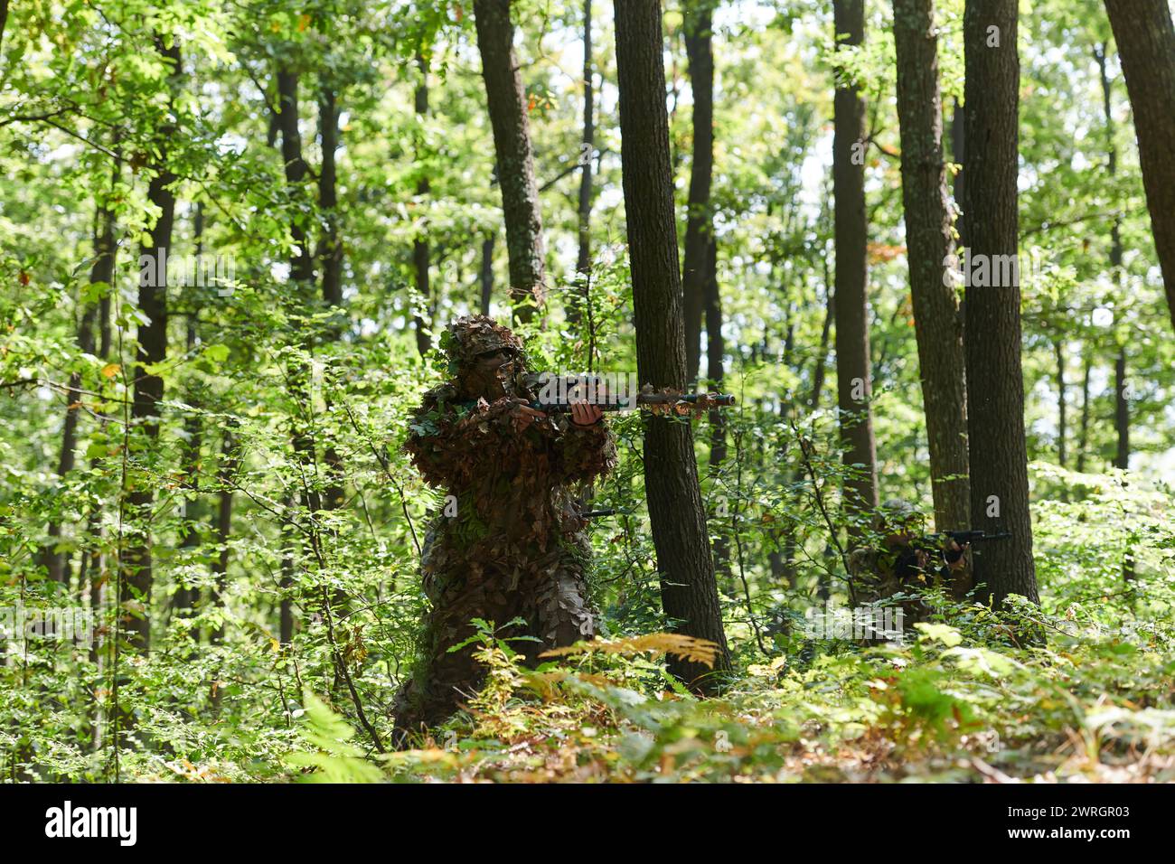 An elite soldier, camouflaged and stealthily navigating through ...