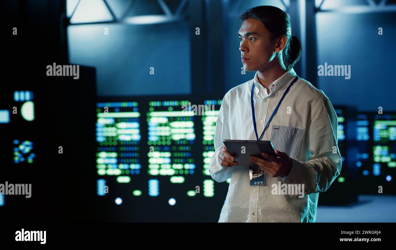 Qualified Engineer Strolling Through Data Center Server Rows Providing Processing Resources For