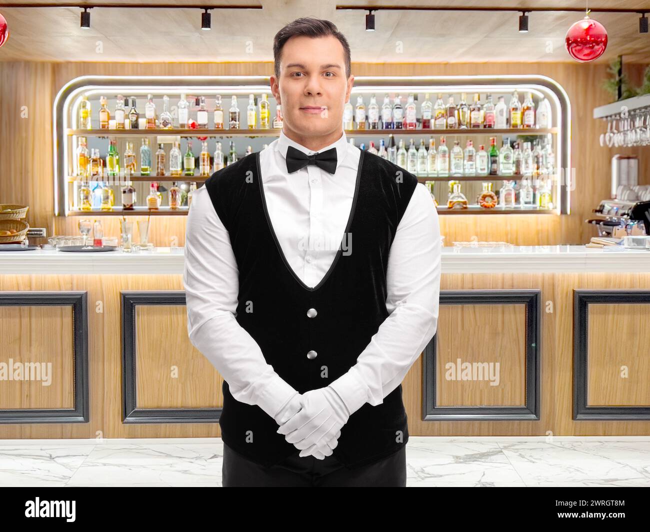 Butler posing at a hotel lobby bar Stock Photo - Alamy