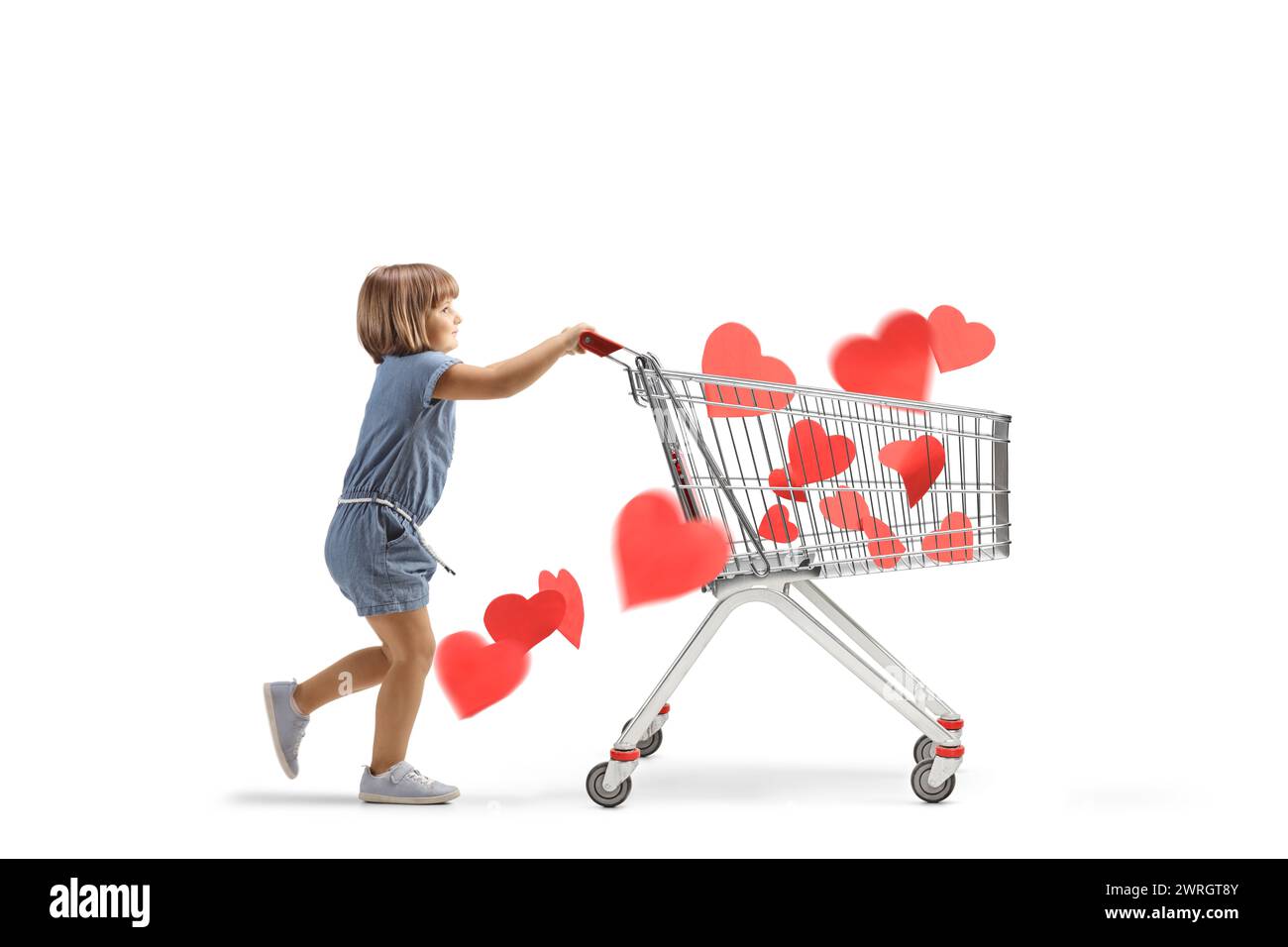 Full length profile shot of a little girl pushing a shopping cart with ...