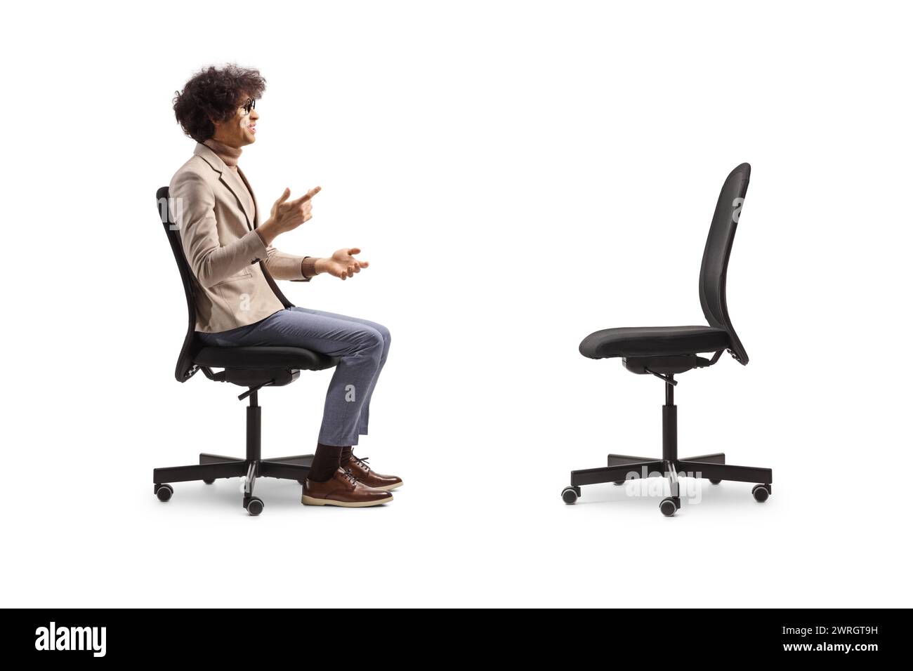 Profile shot of a man talking and sitting in an office chair opposite ...