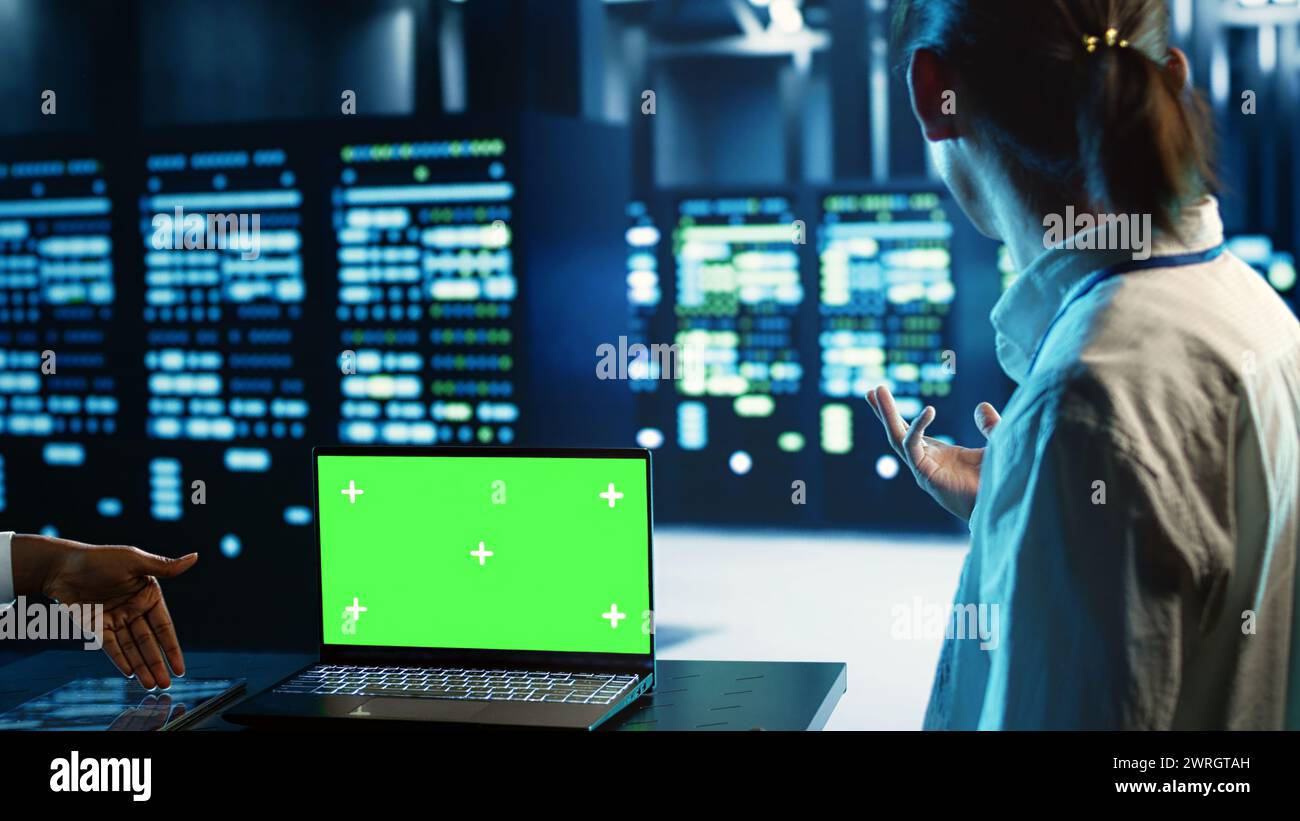 Engineering coworkers using mockup laptop to implement artificial intelligence parallel ...