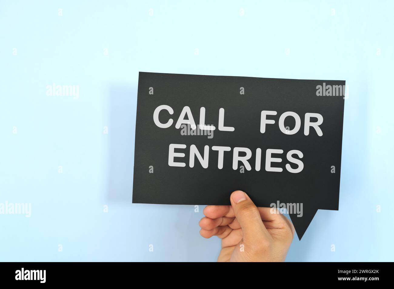 Human hand holding speech bubble with written phrase Call for Entries ...