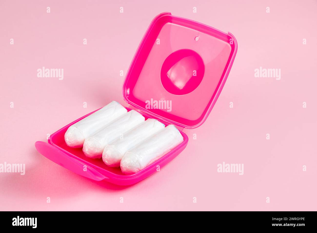 Tampons in pink box. Feminine hygiene products on pastel background ...