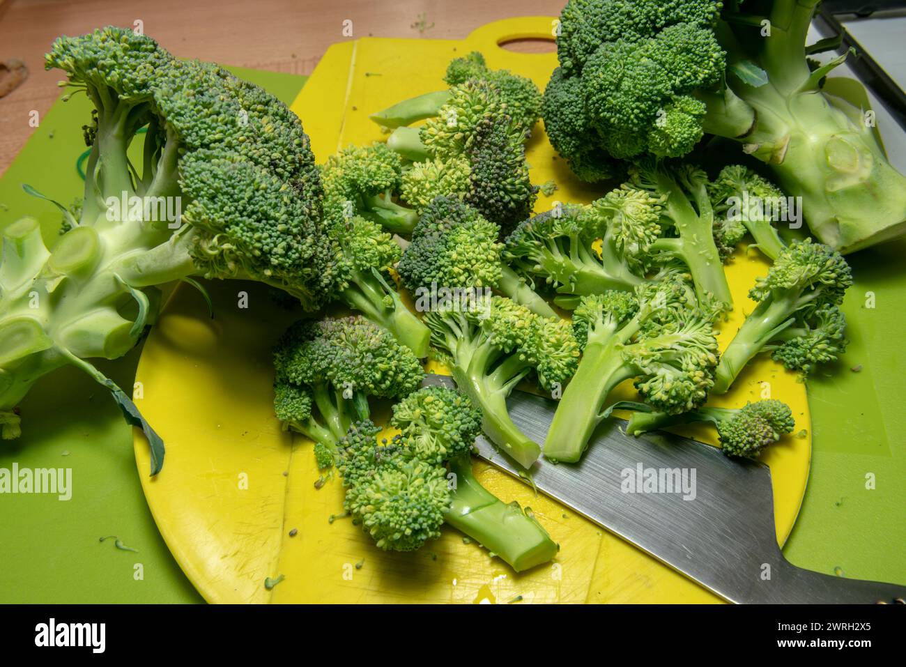 Broccoli in the kitchen on the cutting board, bright green, nutritious ...