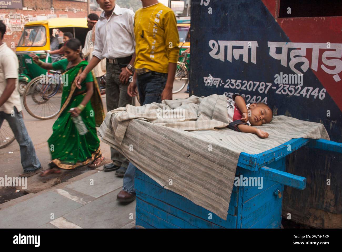 NEW DELHI, INDIA - OCTODER 29,2006: A little Indian boy sleeping on the ...