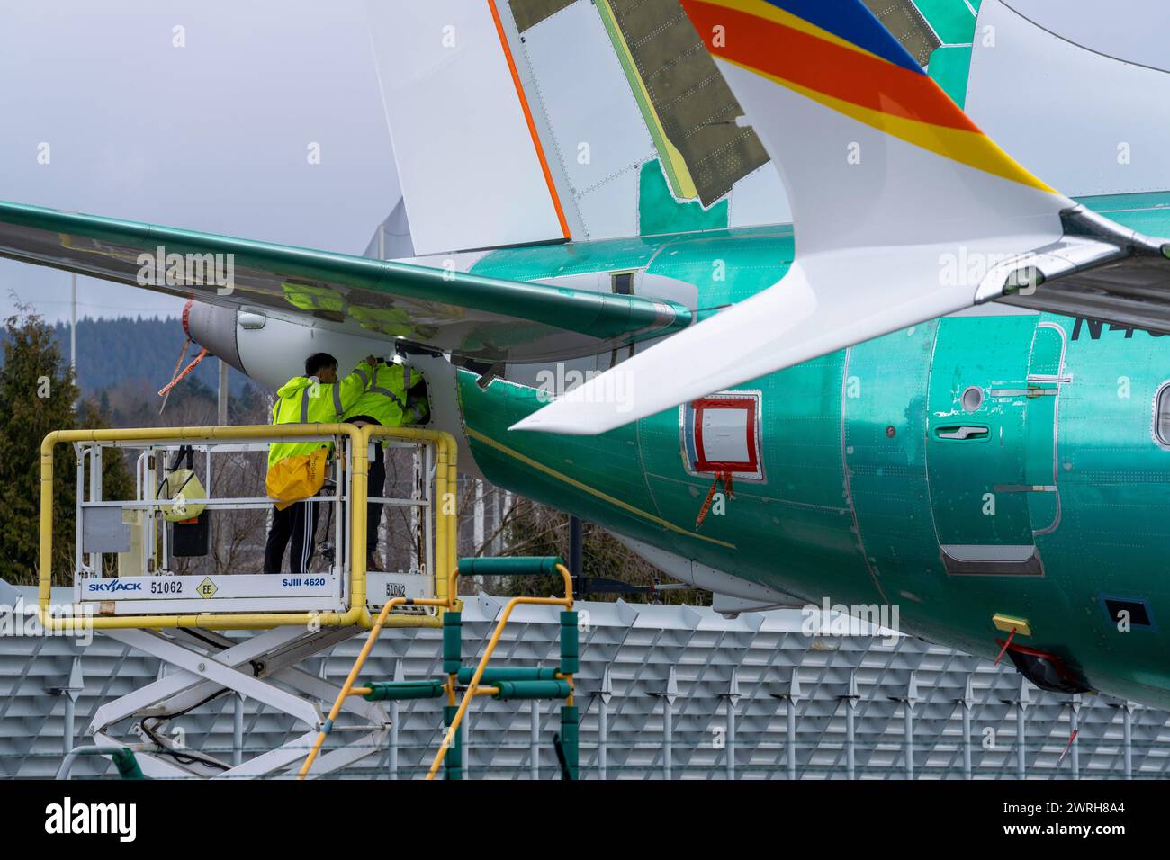 Renton, Washington, USA. 12th Mar, 2024. Technicians on a scissor lift ...