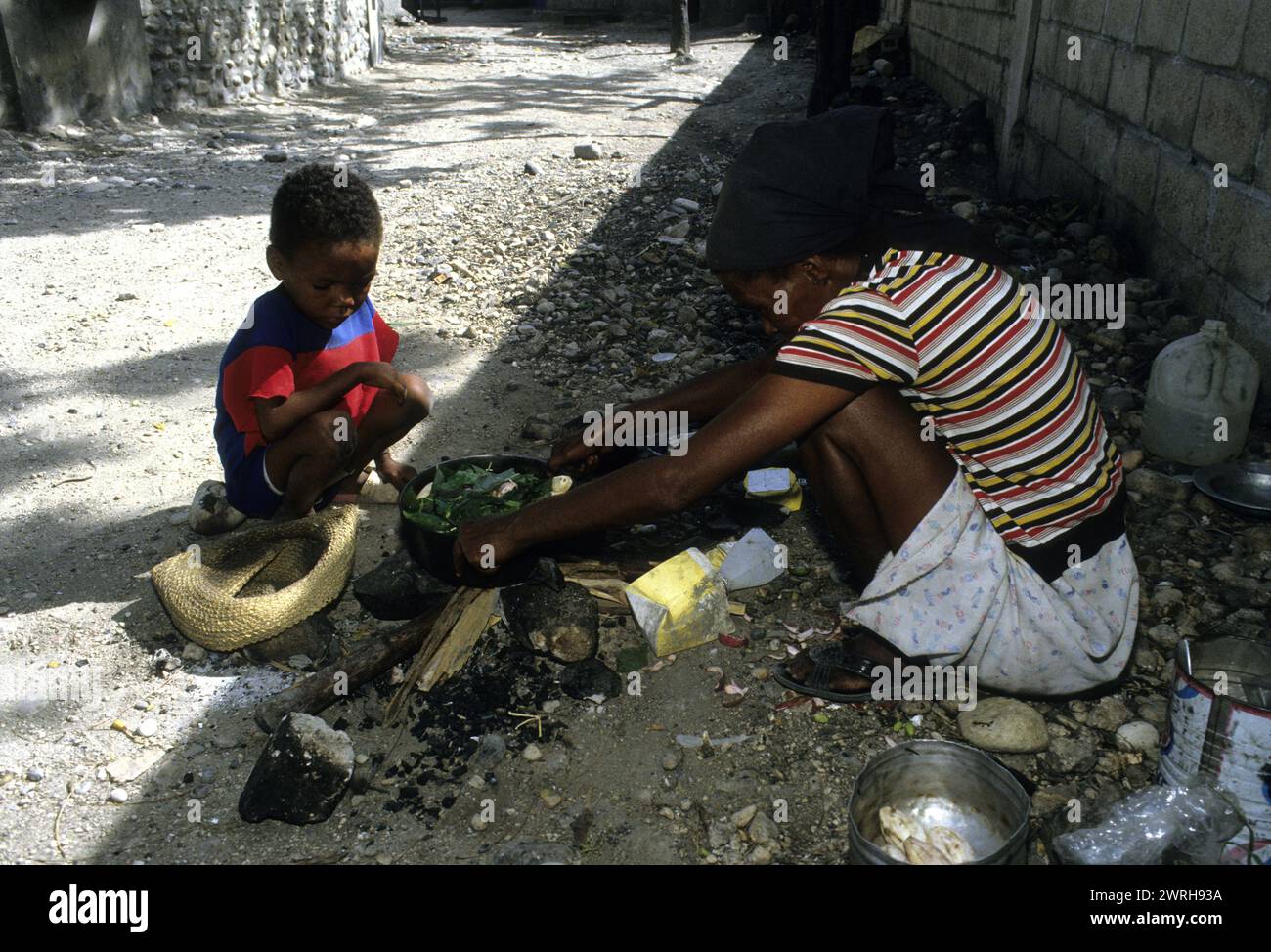 May 18, 1994;Port -au-Prince, Haiti-A mother and child try to cook a ...