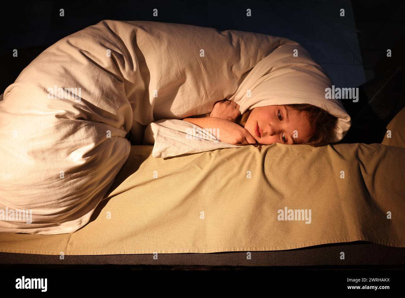 Little girl hiding from monster in duvet at night Stock Photo - Alamy