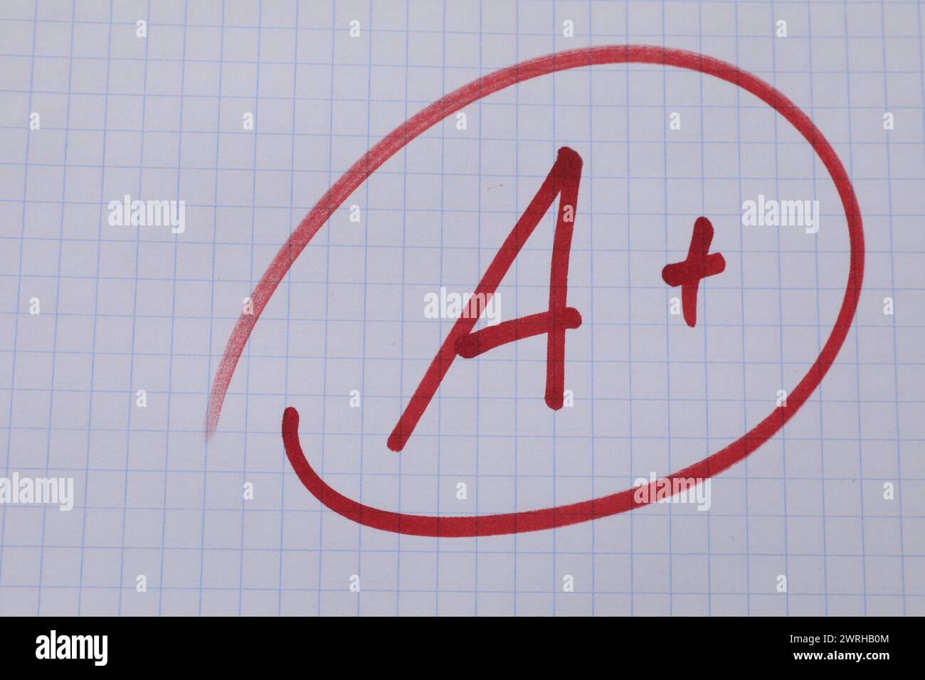 School grade. Red letter A with plus symbol on notebook paper, top view ...