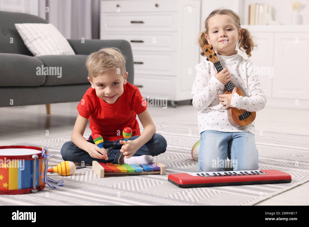Little children playing toy musical instruments at home Stock Photo - Alamy