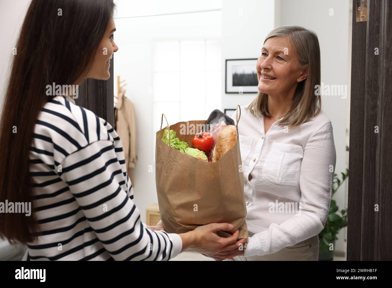 Food delivery courier giving woman hi-res stock photography and images ...