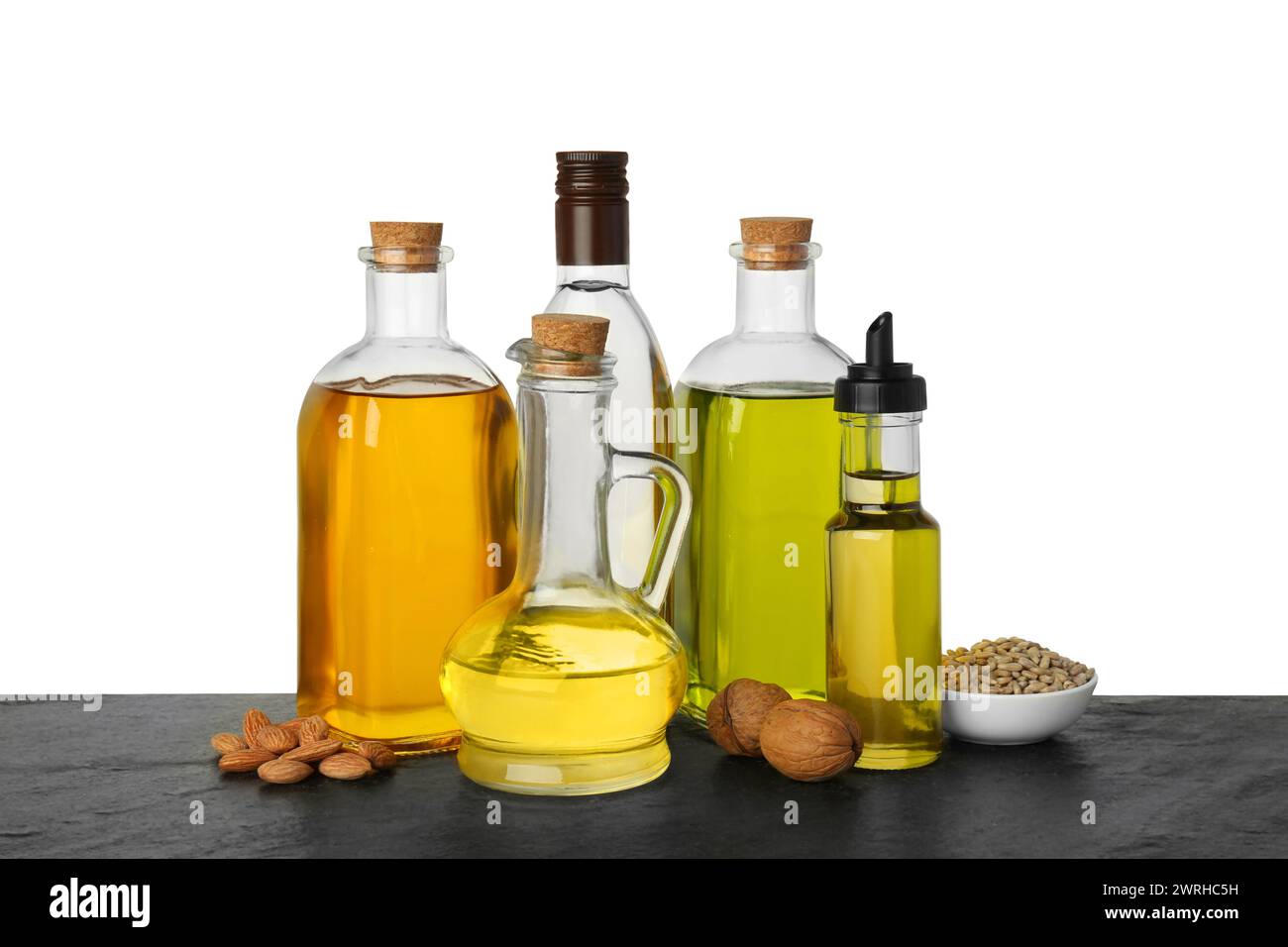 Vegetable fats. Different cooking oils and ingredients on wooden table ...