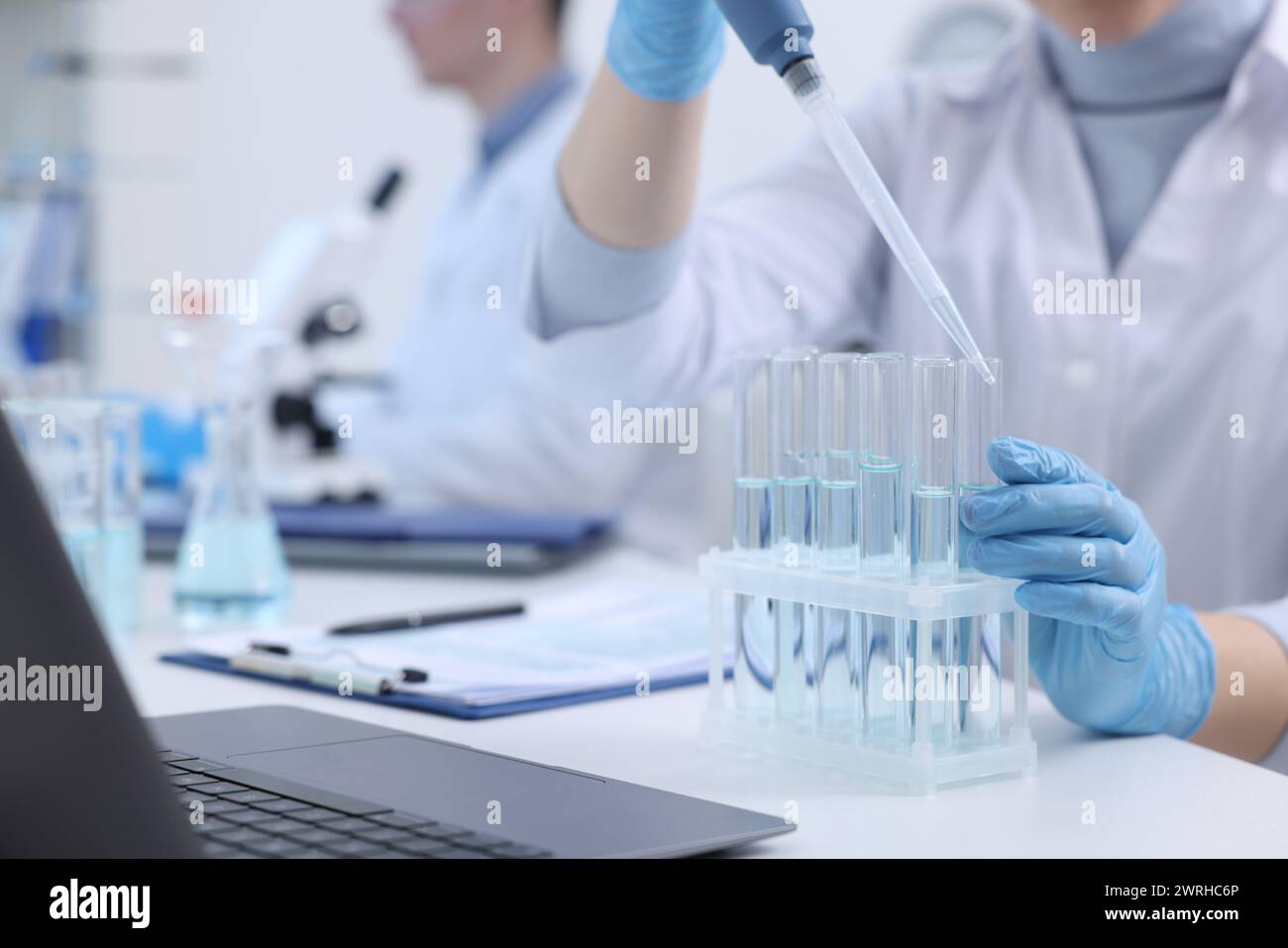 Young scientist dripping sample hi-res stock photography and images - Alamy