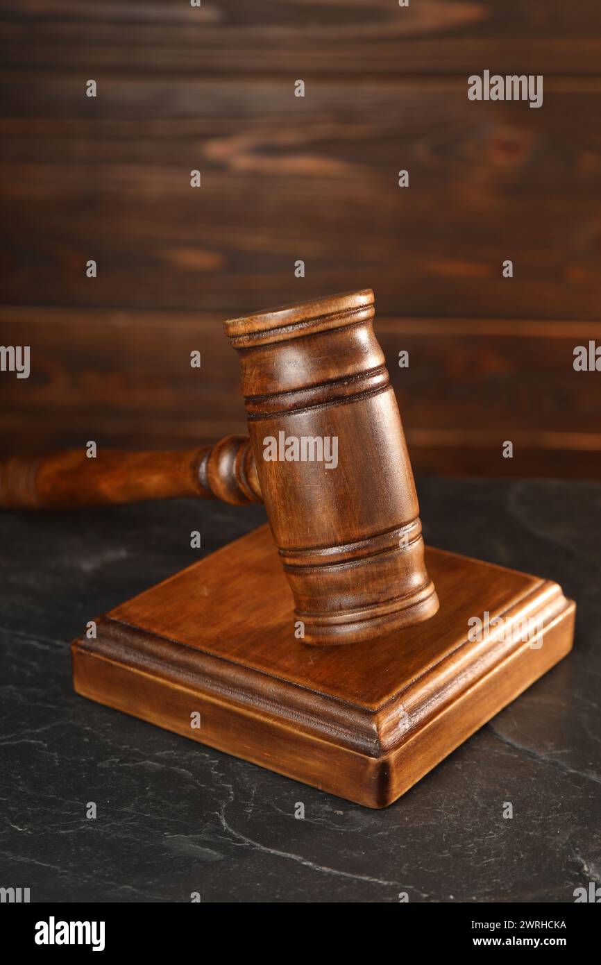Wooden gavel and sound block on dark textured table, closeup Stock ...