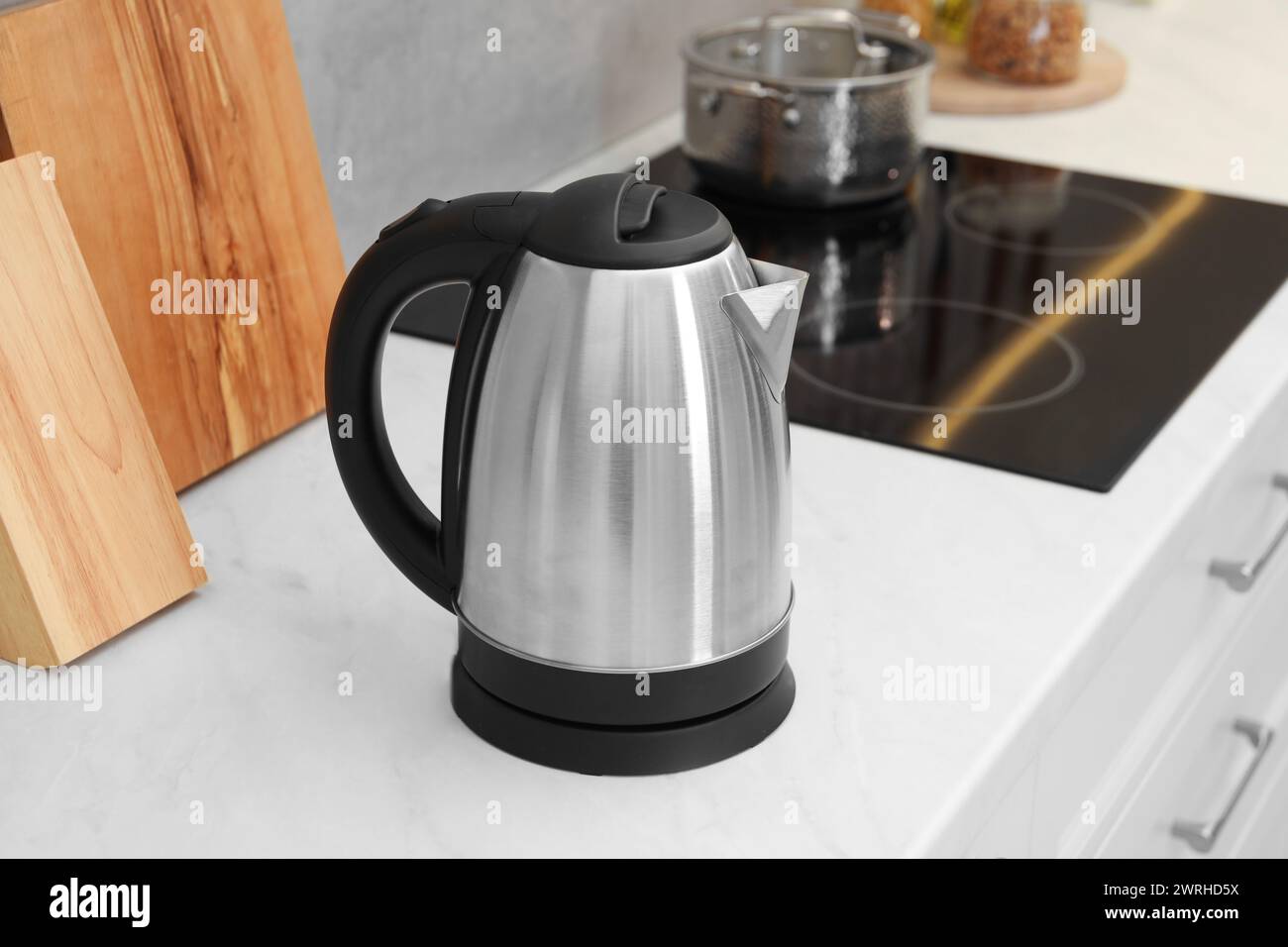 Modern electric kettle on counter in kitchen Stock Photo - Alamy