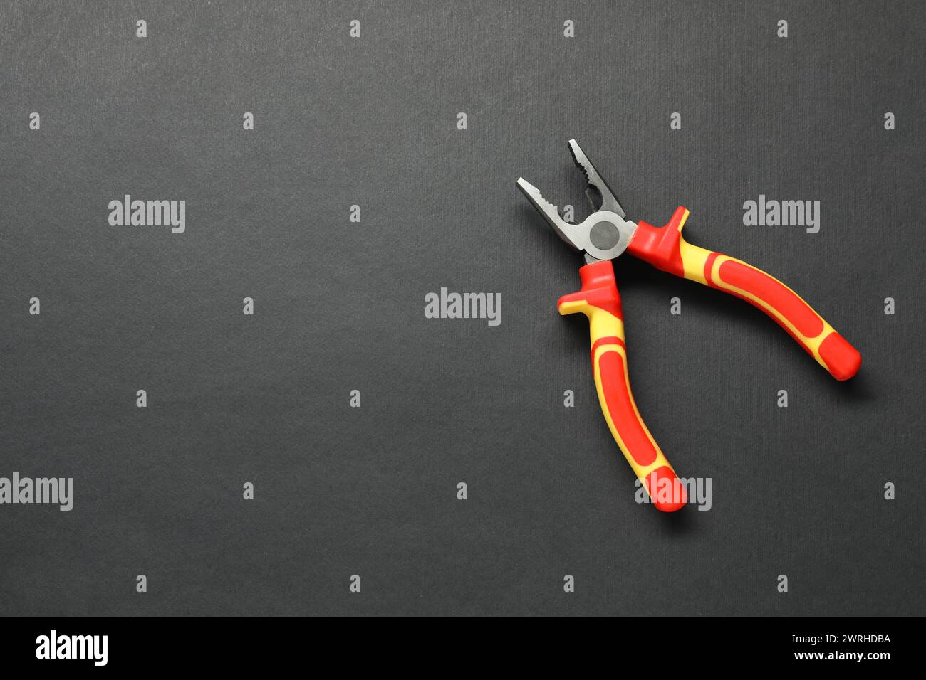 Combination pliers on black background, top view. Space for text Stock ...