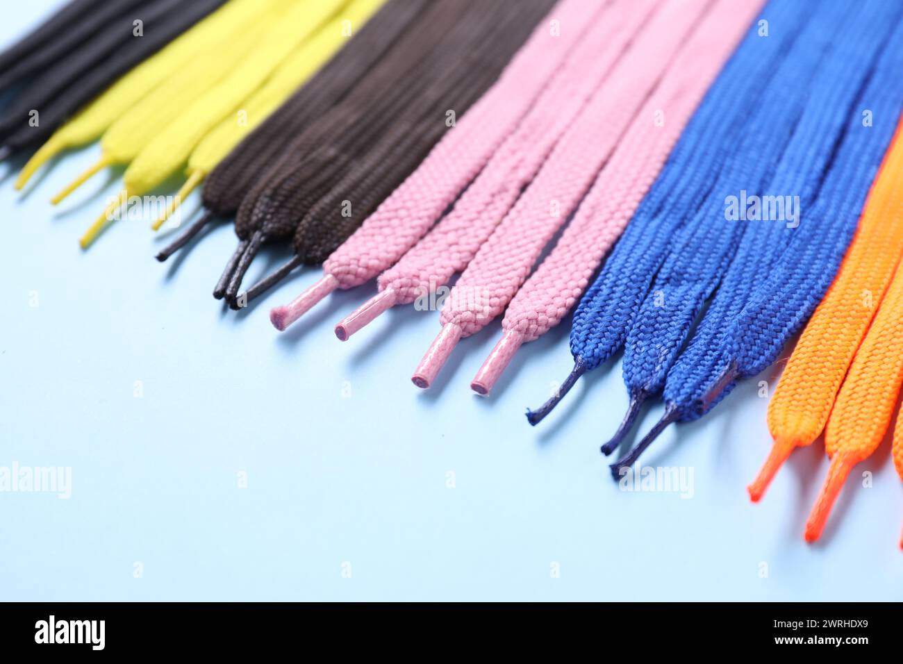 Many colorful shoe laces on light blue background, closeup Stock Photo ...