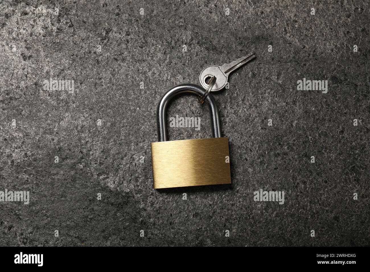 Steel padlock with key on grey table, top view Stock Photo - Alamy