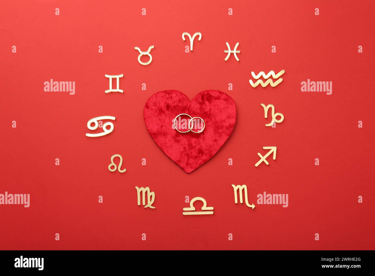 Zodiac signs, heart and wedding rings on red background, flat lay Stock ...