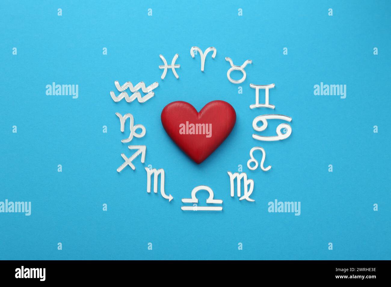 Zodiac signs and heart on light blue background, flat lay Stock Photo ...