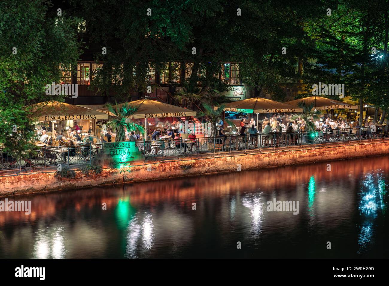 Night view of riverside restaurant and bar in the Nuremberg old town ...
