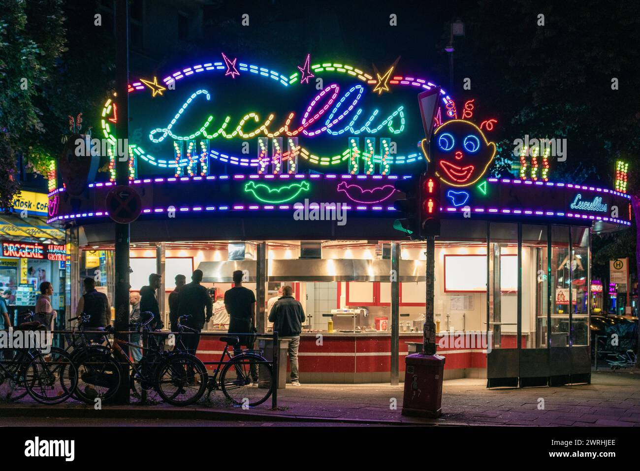 Bright neone lights of a hot dog stall at night in the famous ...