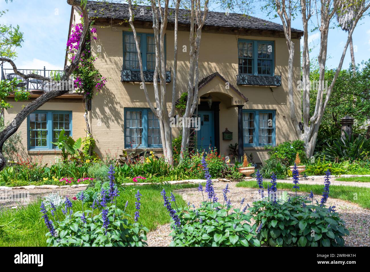 Two-story house with floral landscaping, in the historic district in ...