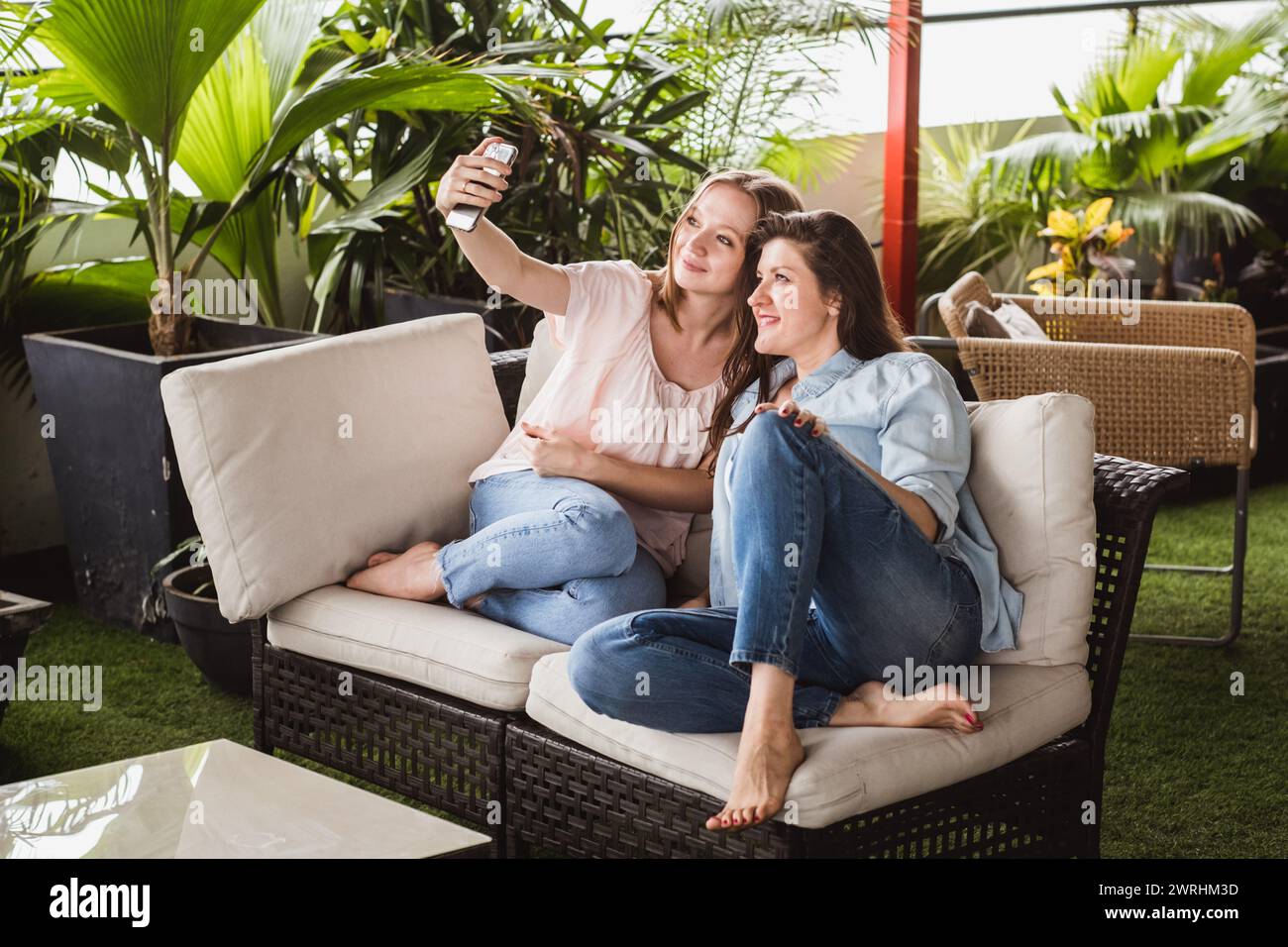 Two girls take photo for social media accounts Stock Photo - Alamy