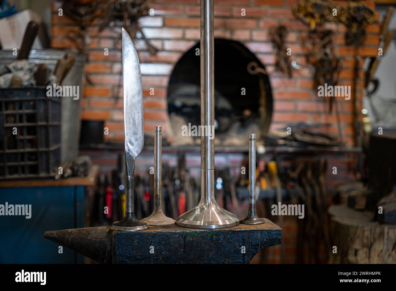 The blade and blanks for forging a knife on an anvil against the ...