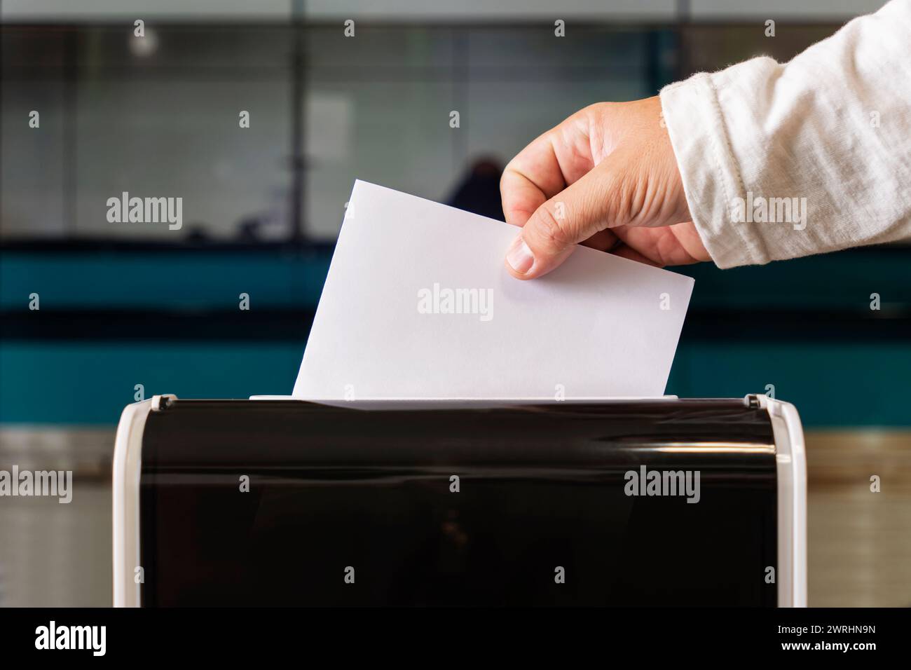 A person casts her ballot during voting for parliamentary elections at ...