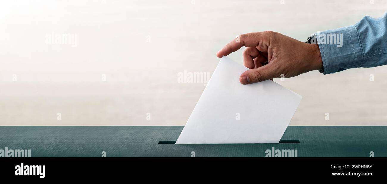 Hand holding ballot paper for election vote concept at white background ...