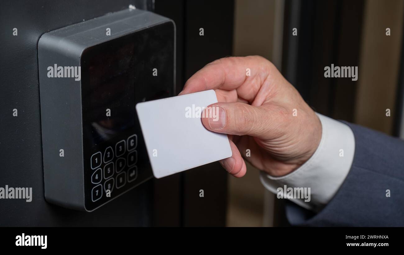 A man opens the door with a card. Modern electronic lock. Keyless Entry ...