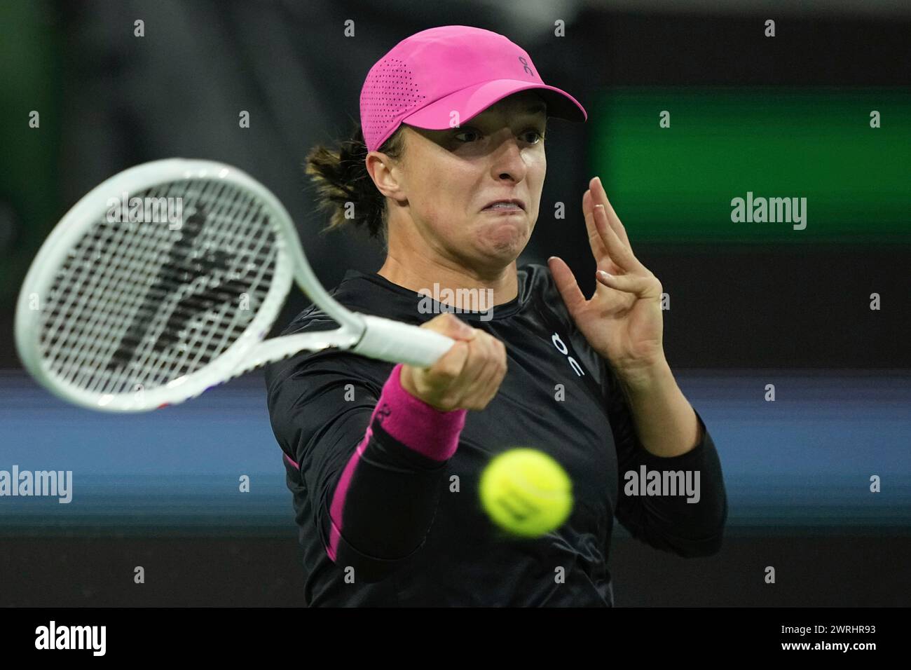 Iga Swiatek, of Poland, returns a shot to Yulia Putintseva, of ...