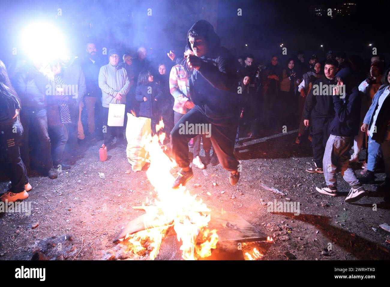 March 12, 2024, Tehran, Iran: An Iranian man jumps over a bonfire on ...