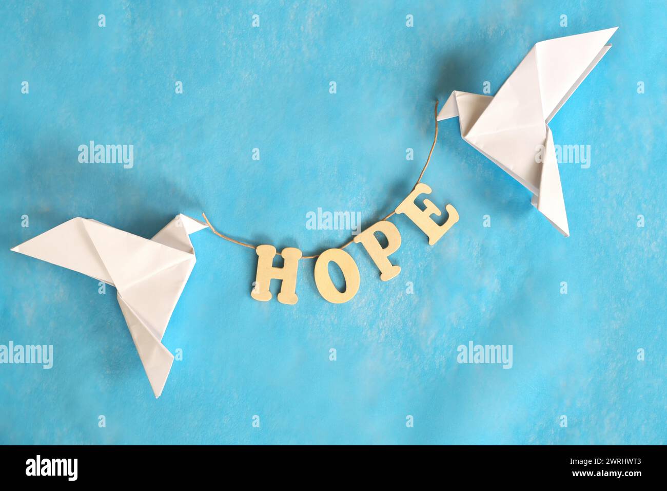 Message of hope concept. White dove origami carrying word letters in ...