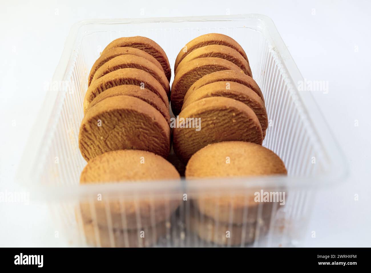 A close-up view of a variety of cookies in a clear plastic storage ...