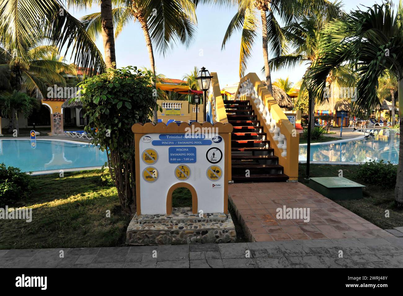 Information stand with pool rules and signs next to a resort swimming ...