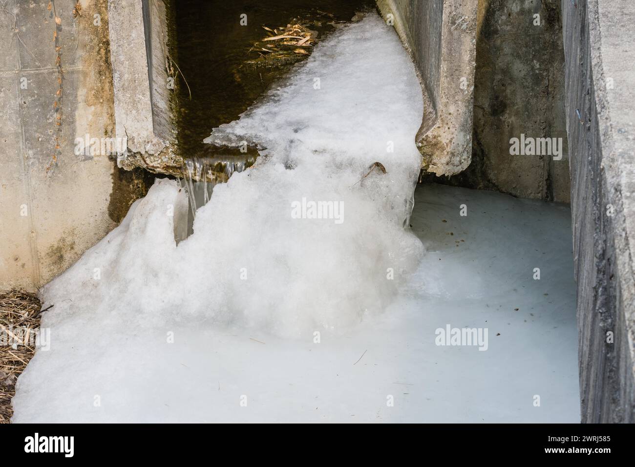 Ice formation at mouth of concrete culvert of flowing water in Daejeon ...