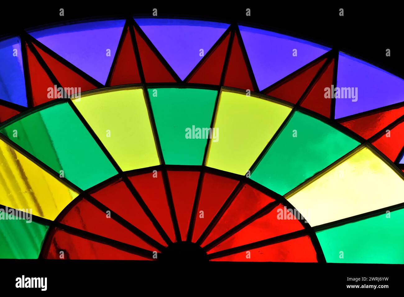 View of a colourful, wheel-shaped stained glass window with colourful ...