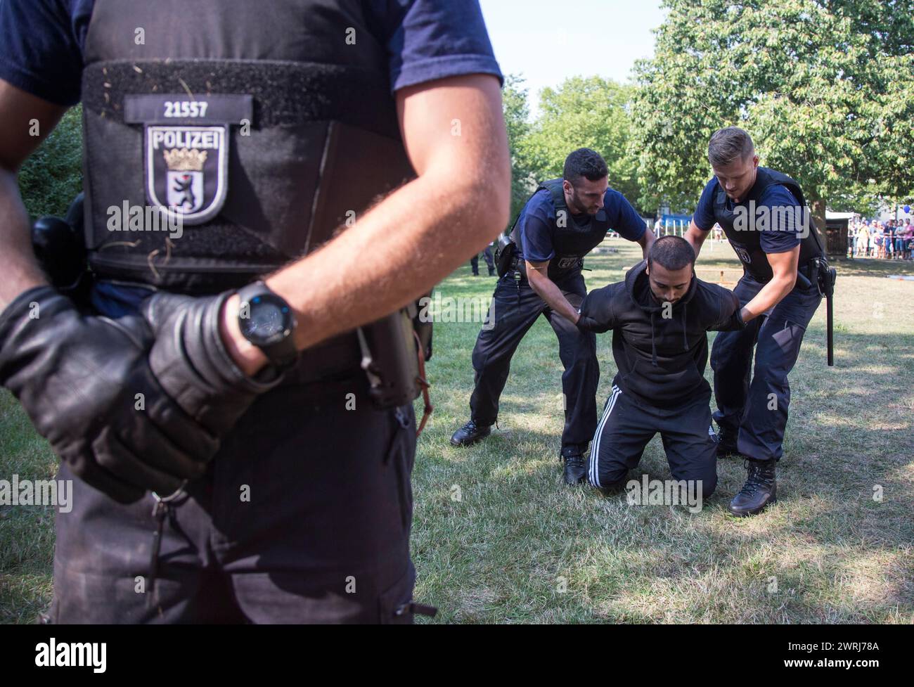 Berlin police officers demonstrate the arrest of a suspect during an ...