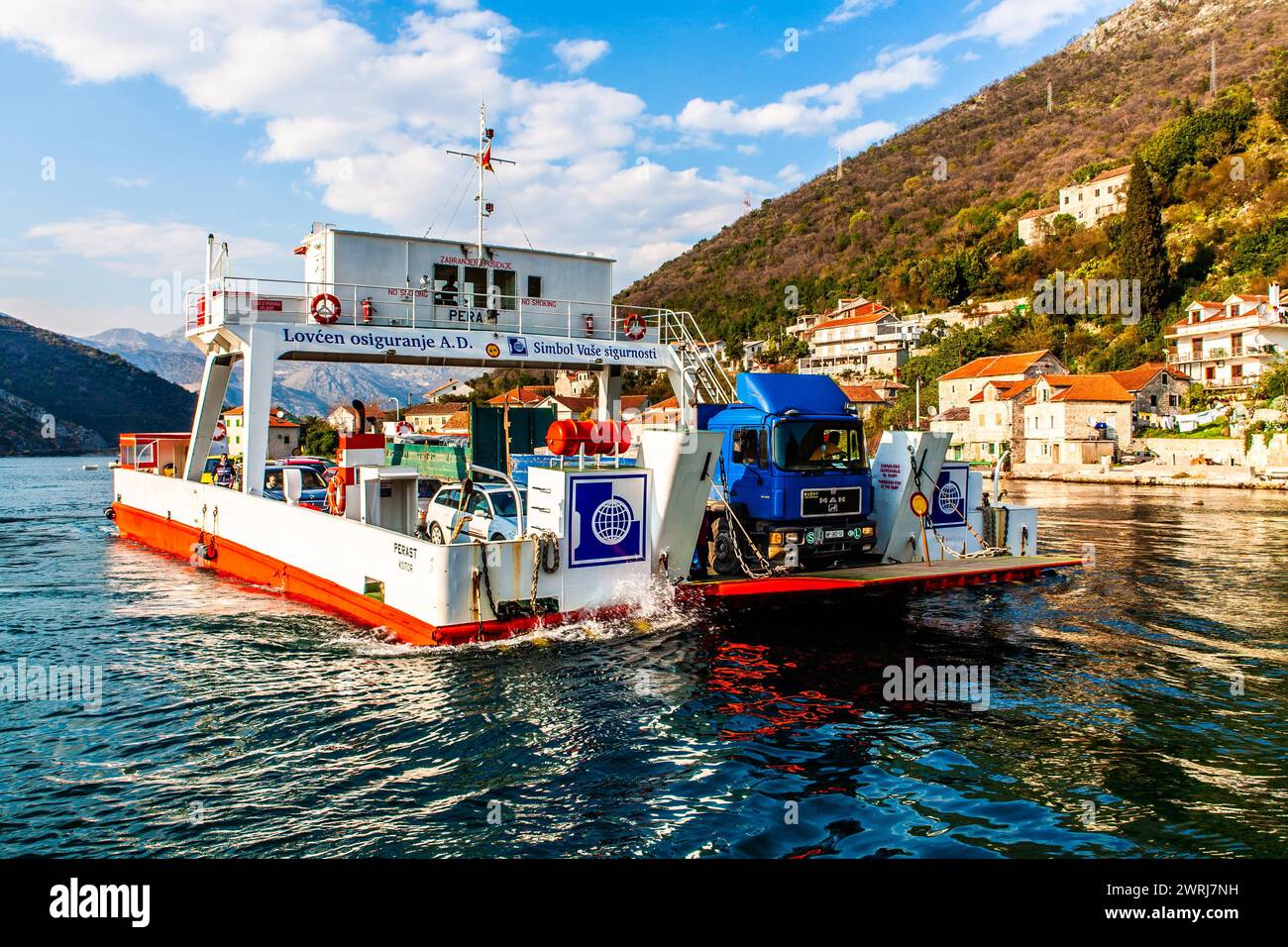 Approach to Kotor by ferry, medieval town of Kotor with winding ...